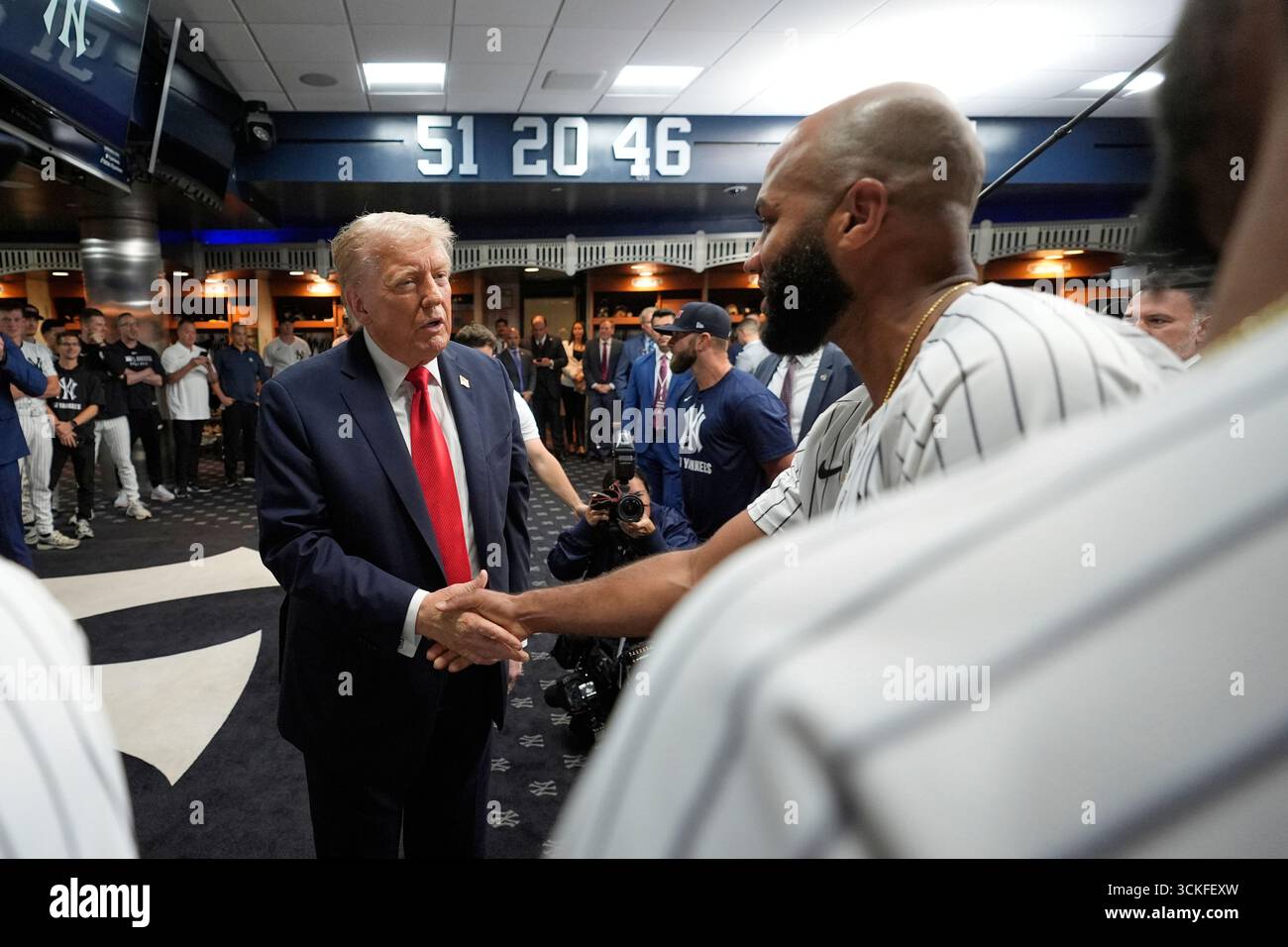 President Donald Trump talks to players in the New York Yankees locker ...