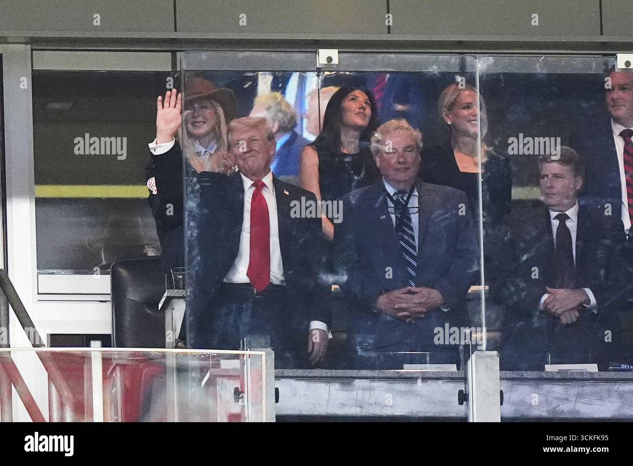 President Donald Trump waves during the second inning of a baseball ...