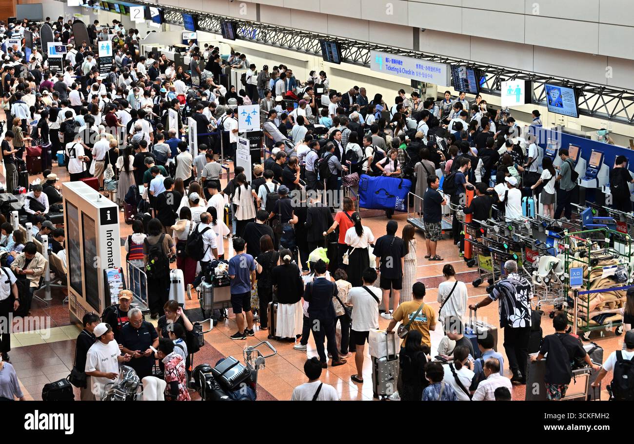 A photo shows Haneda Airport is crowded with people lining up at ...