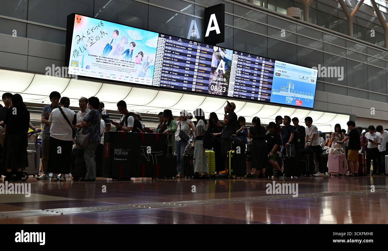 A photo shows Haneda Airport is crowded with people lining up at ...