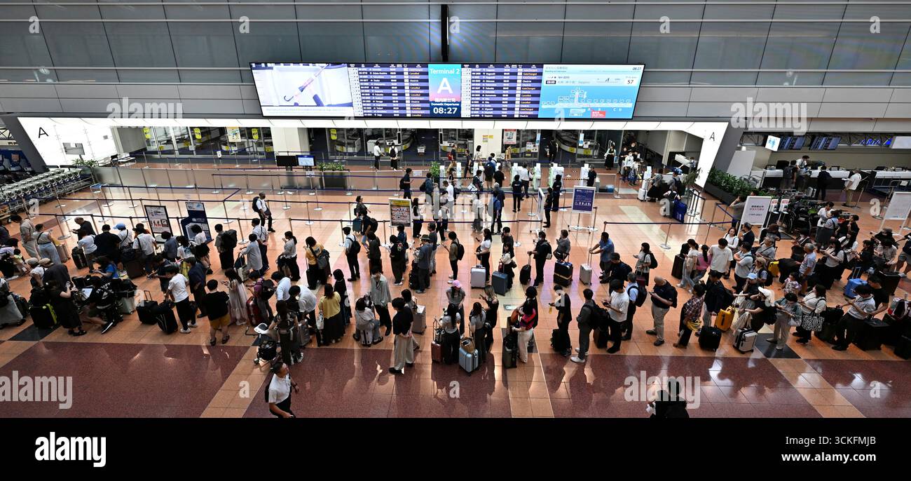 A photo shows Haneda Airport is crowded with people lining up at ...