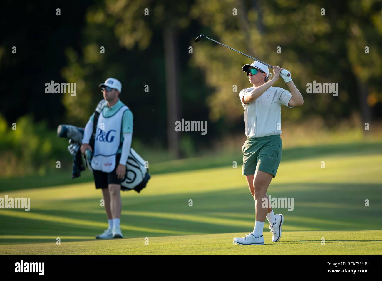 Gigi Stoll, right, hits an approach shot on the 18th hole during the ...