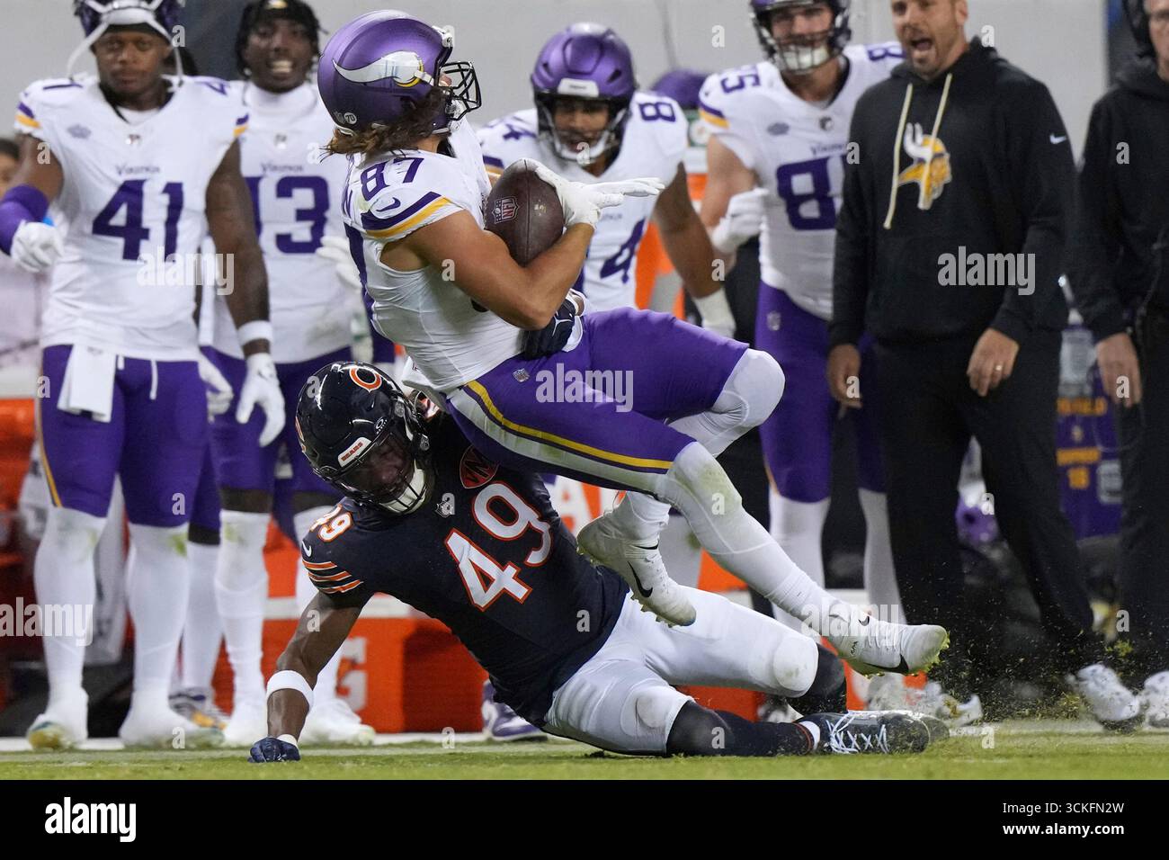 Minnesota Vikings tight end T.J. Hockenson, top, is tackled by Chicago ...