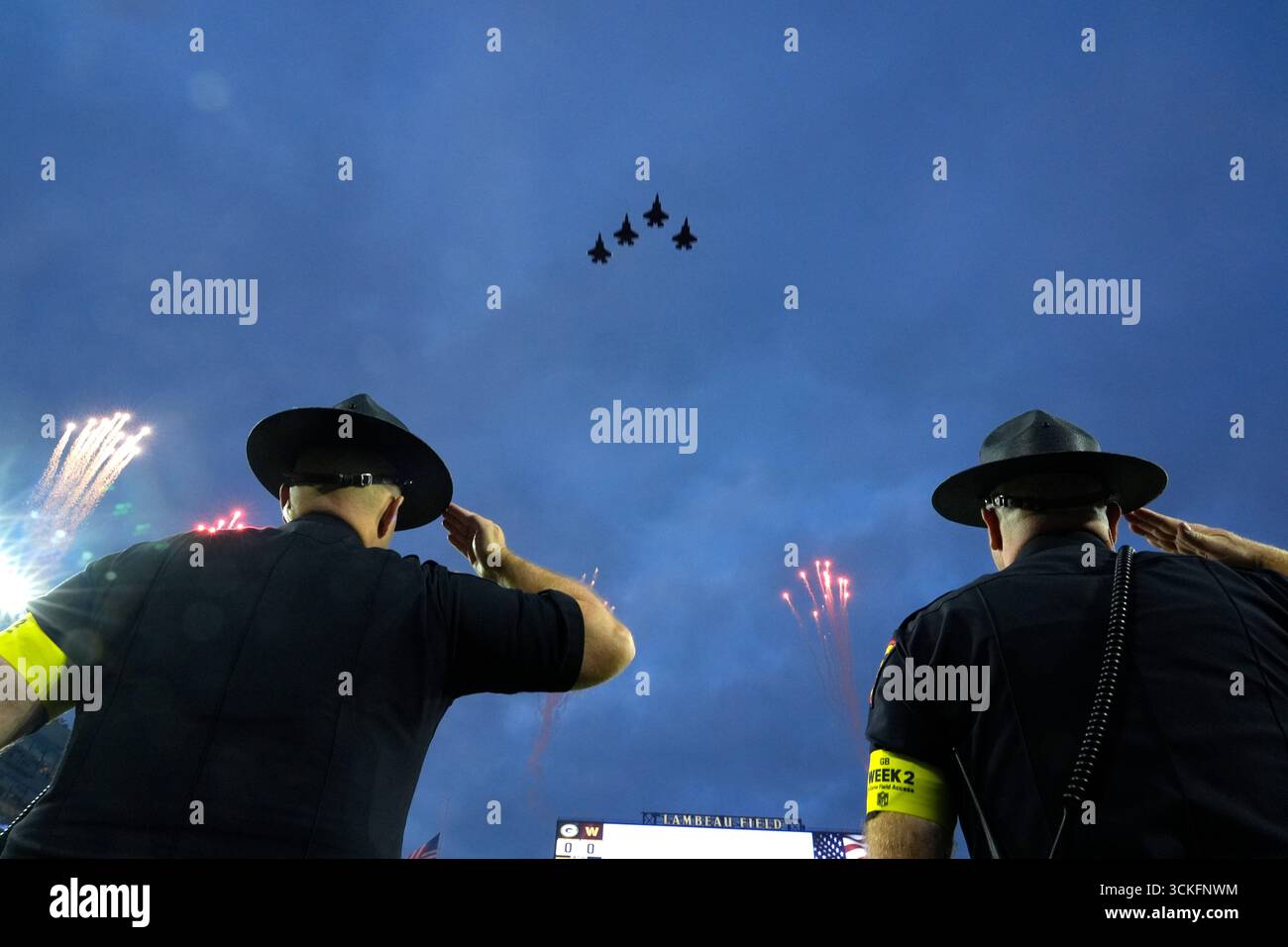 Law enforcement pause for the national anthem as jets fly over Lambeau ...