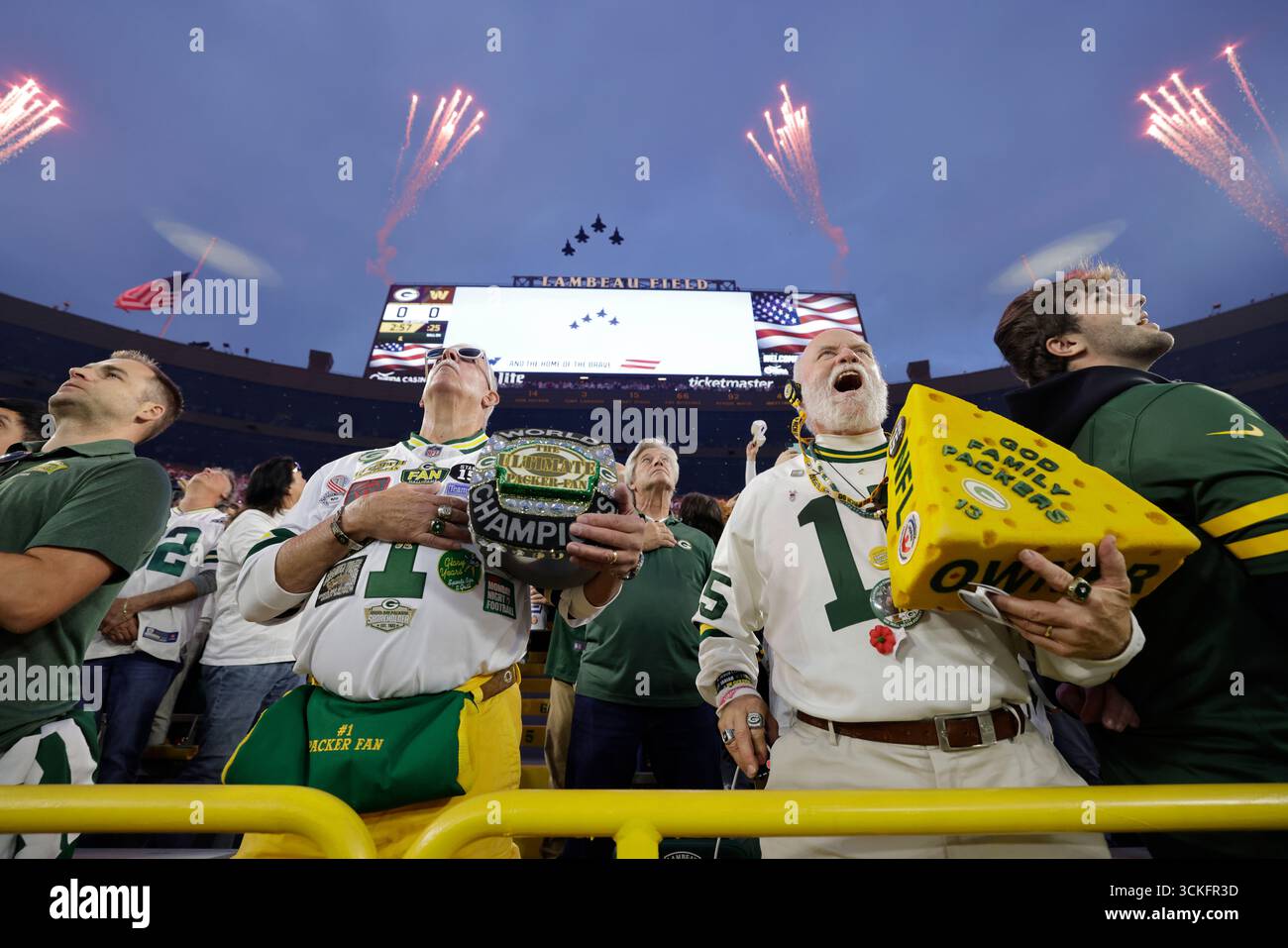 Fans cheer during the national anthem as jets fly over Lambeau Field ...