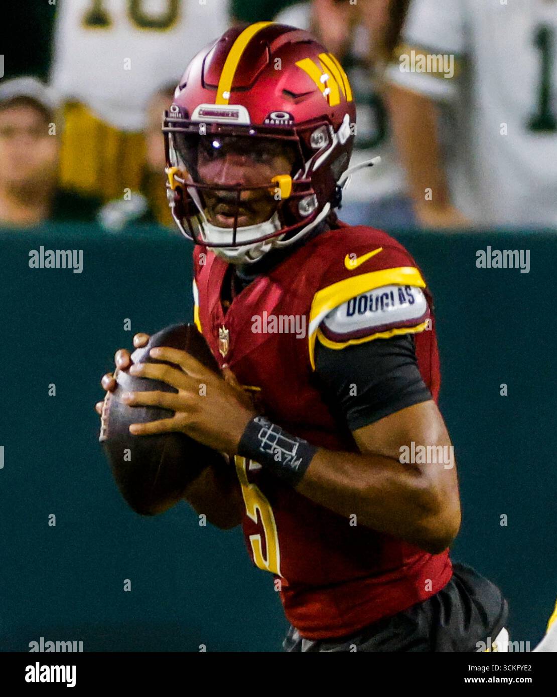 Washington Commanders quarterback Jayden Daniels looks to pass in the ...