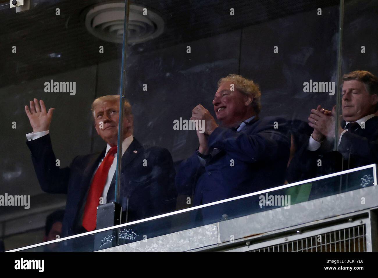 President Donald Trump, left, waves next to New York Yankees president ...
