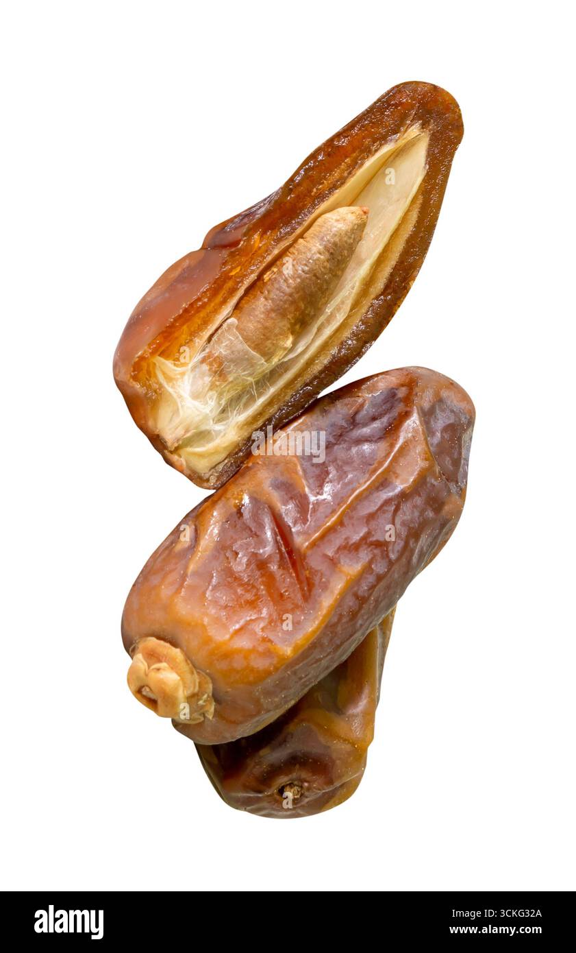 Ripe dried date palm fruits with half in stack are isolated on white ...