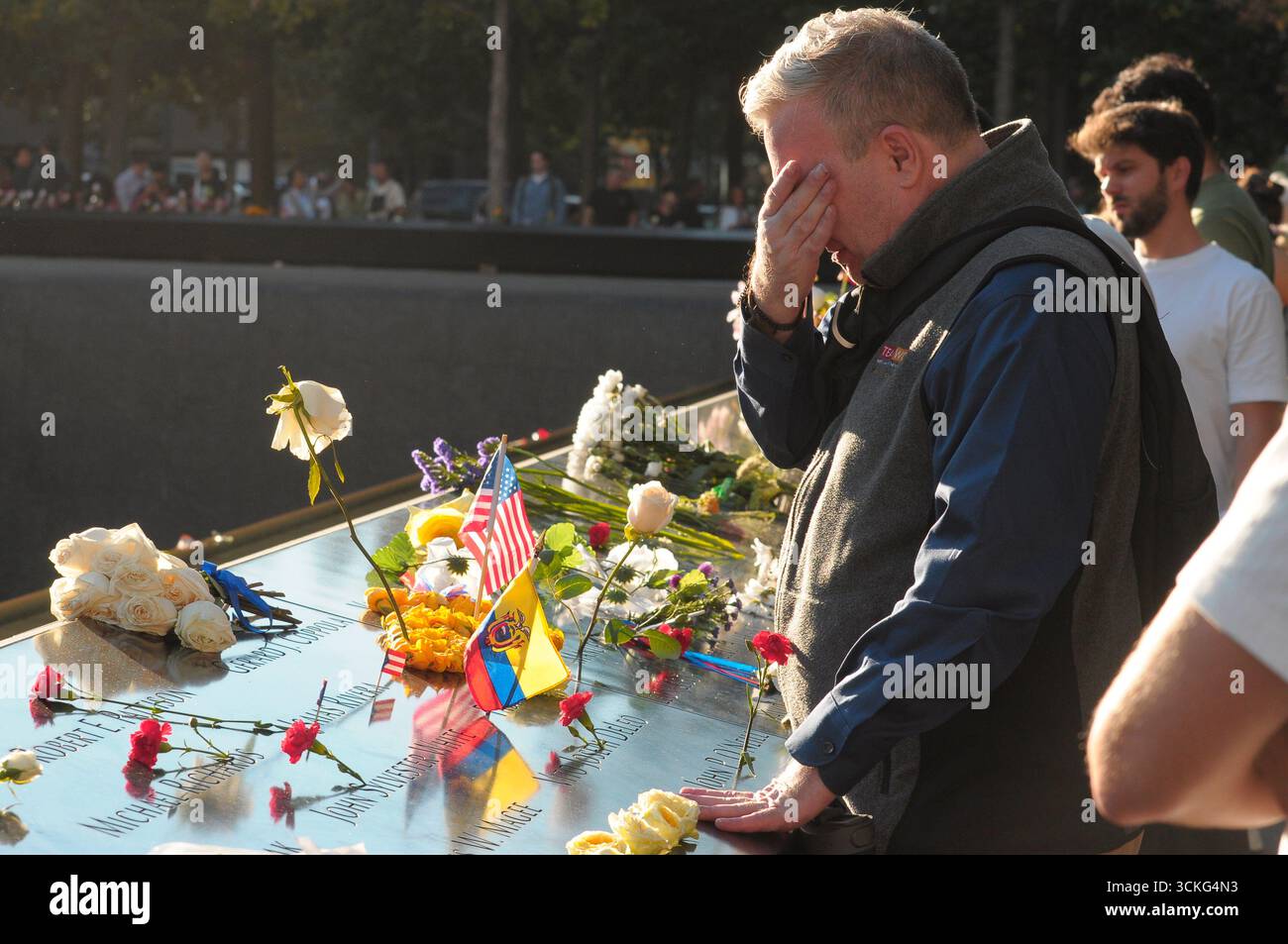 A person sheds tears while paying tribute at the September 11 memorial ...