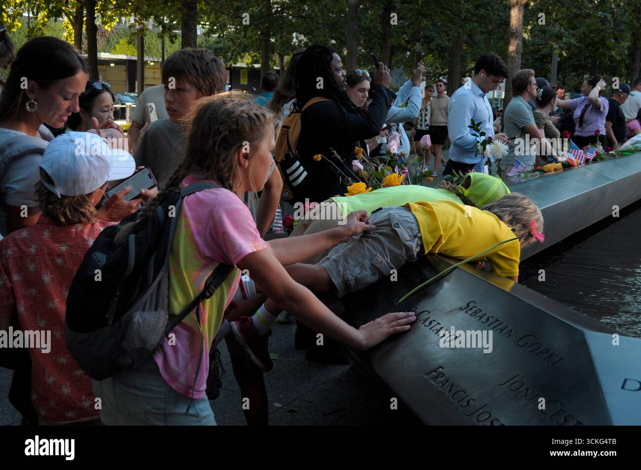 Children visit the September 11 memorial pool. On the 24th anniversary ...