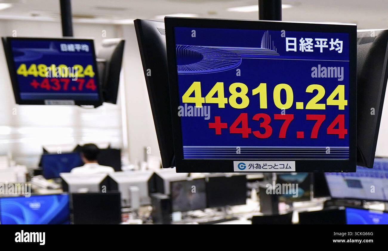 Monitors at a foreign exchange trading company in Tokyo show the 225 ...