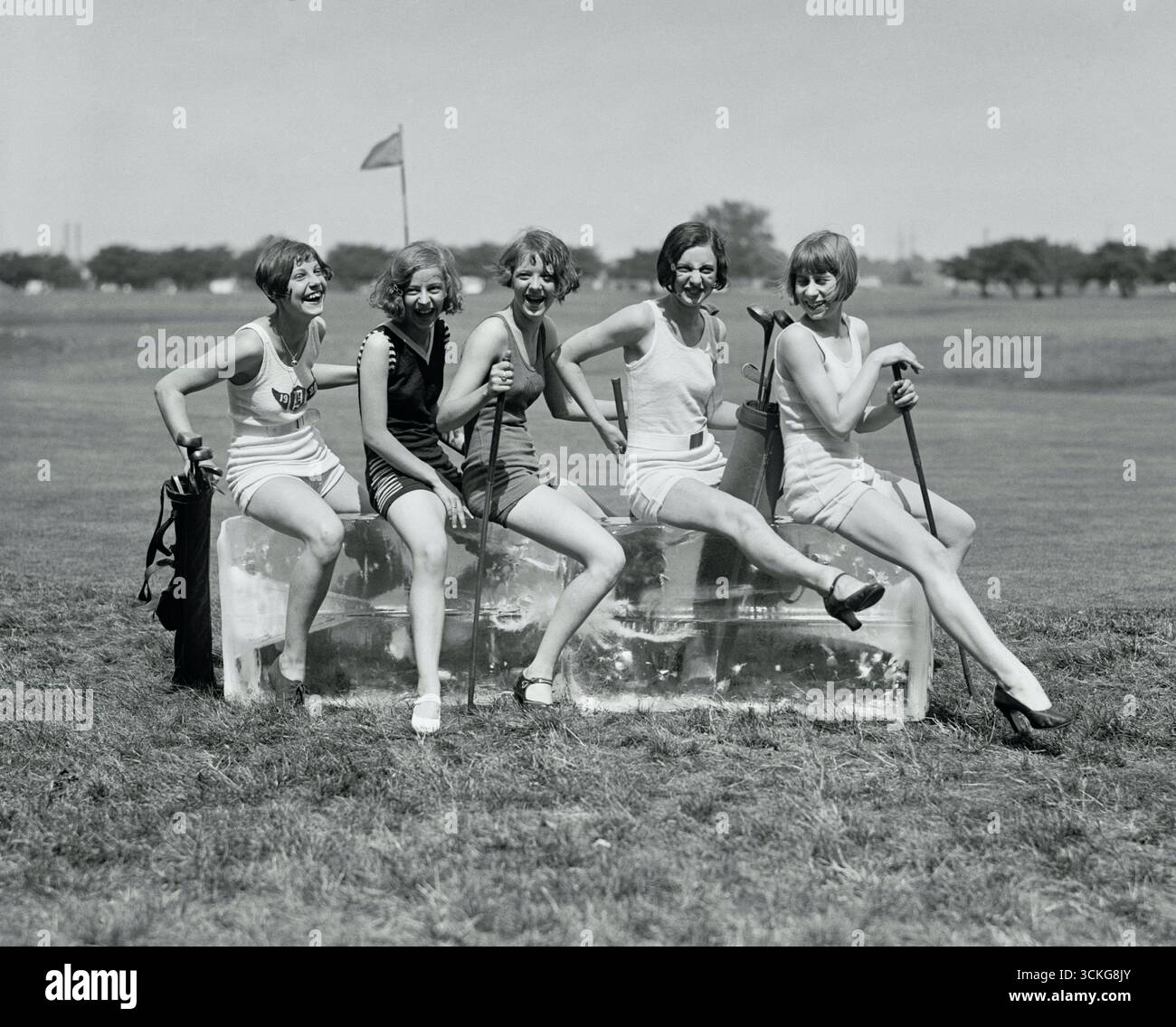 Women on a golf course sitting on two blocks of ice. Dorothy Kelly ...