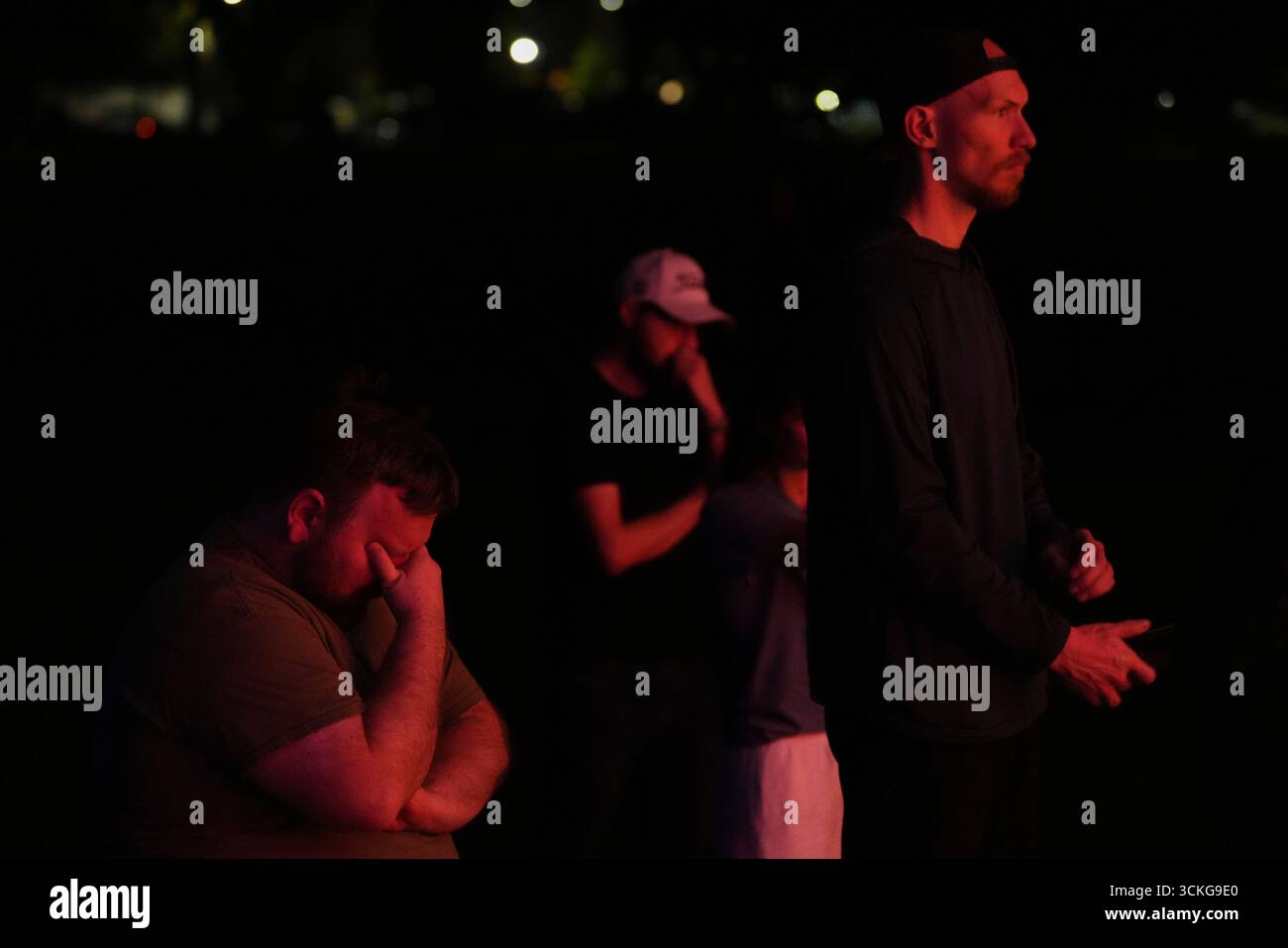 Aaron Tharp of Orem, Utah, left, attends a vigil for Charlie Kirk, the ...