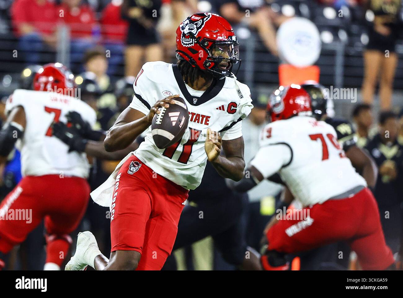 September 11,2025: NC State quarterback CJ Bailey (11) scrambles away ...