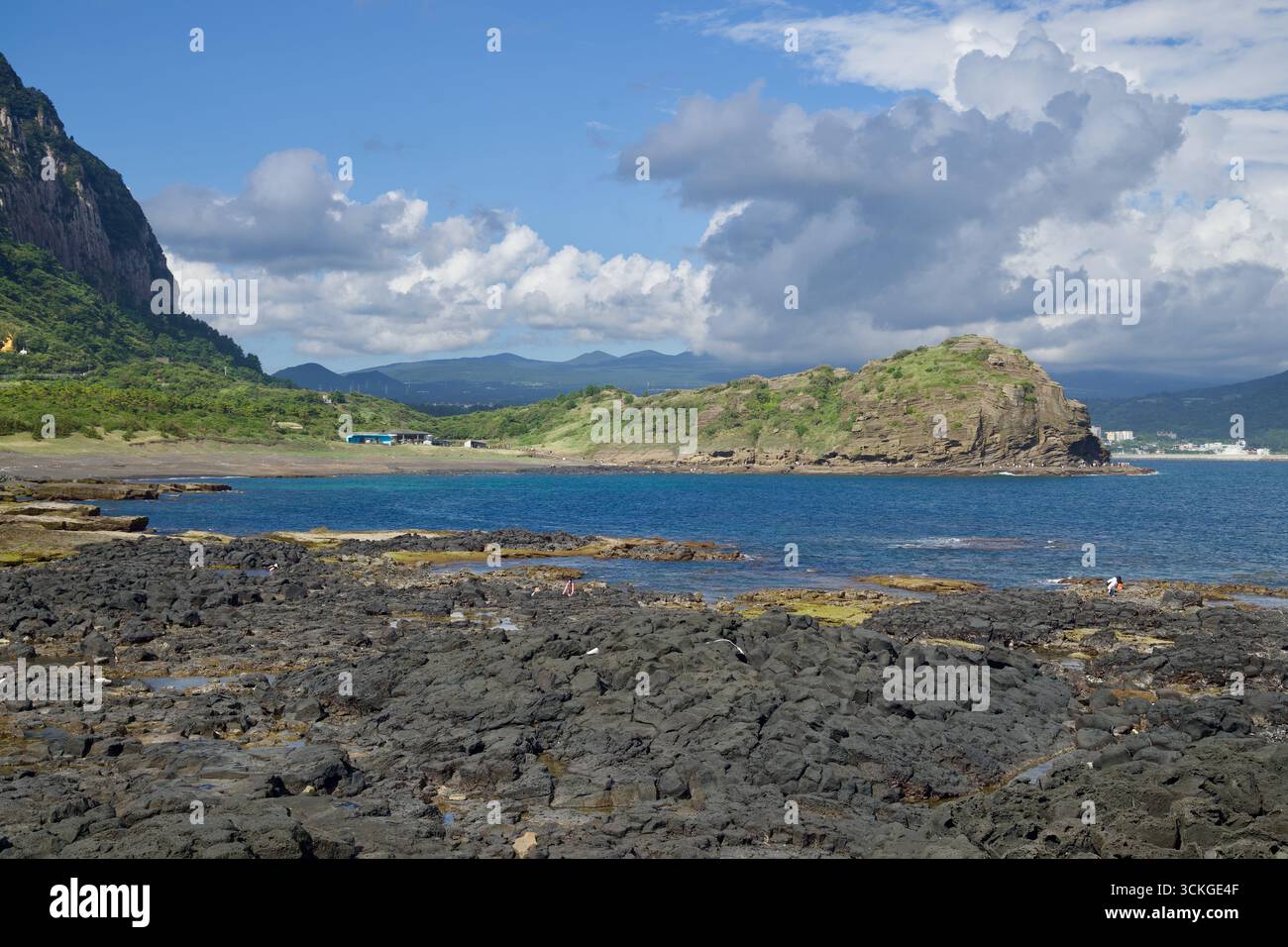 Rugged basalt blocks lead the eye across Sagye Bay to the layered ...