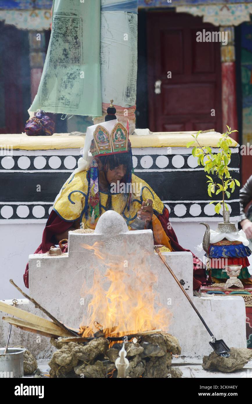 Monks in traditional Tibetan robes perform rituals at Thiksey Monastery ...