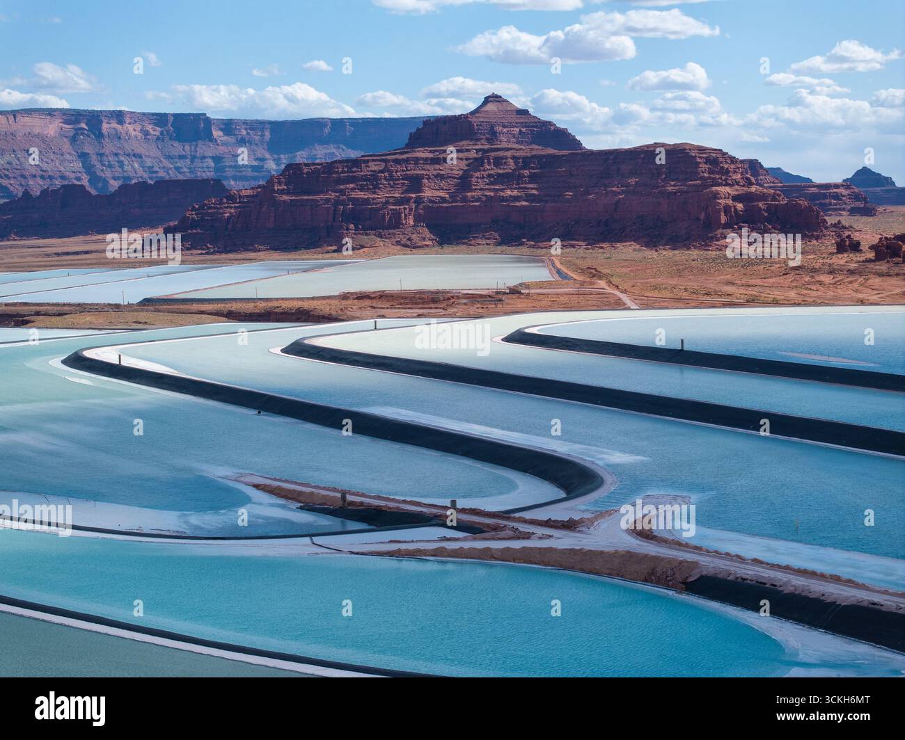 Aerial view of bright turquoise evaporation ponds contrasting with the ...