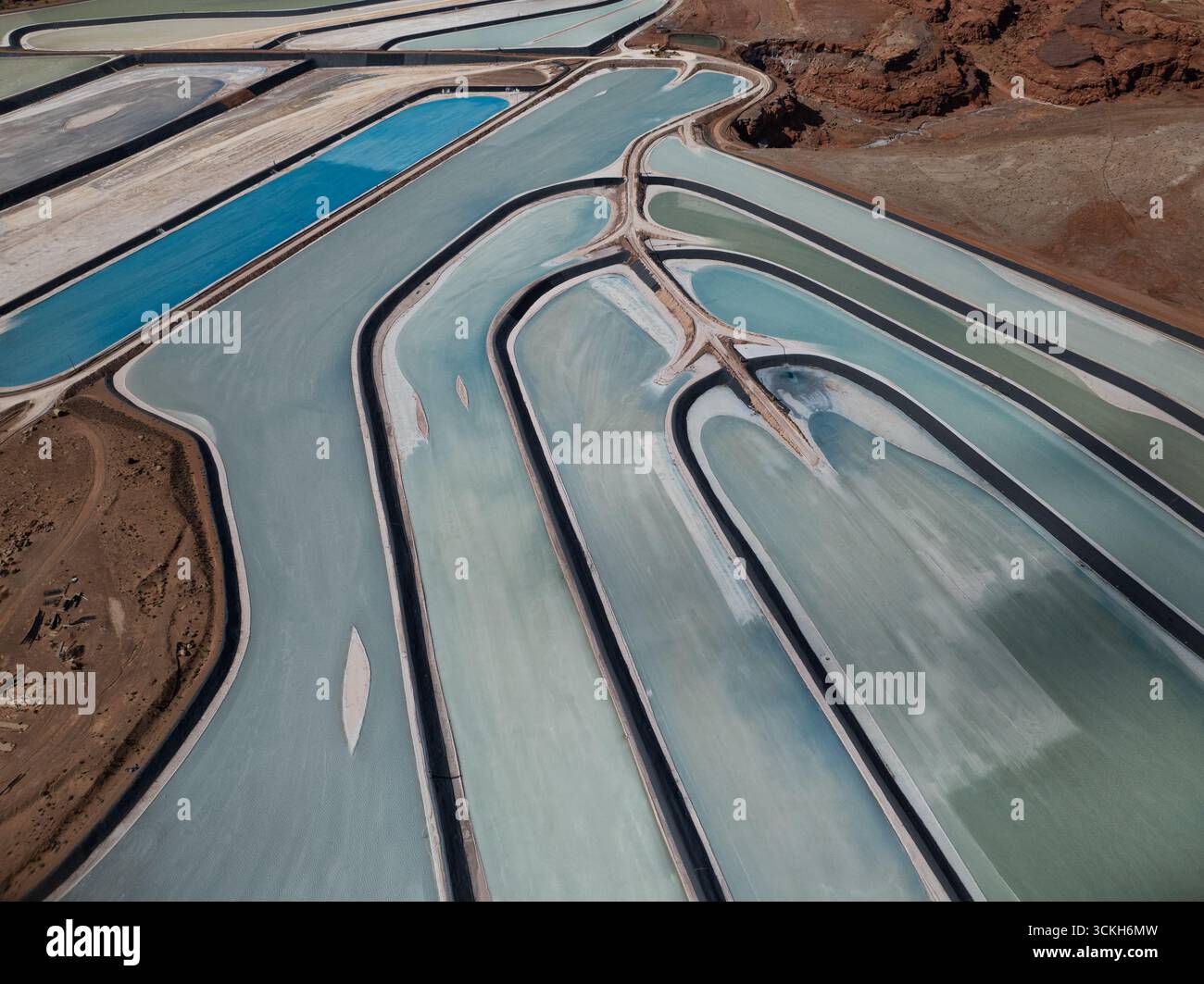 Aerial view of vibrant evaporation ponds create a geometric tapestry of ...