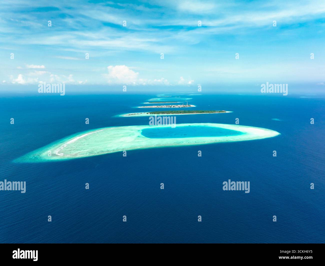 Aerial view of turquoise lagoons embracing islands like jewels ...