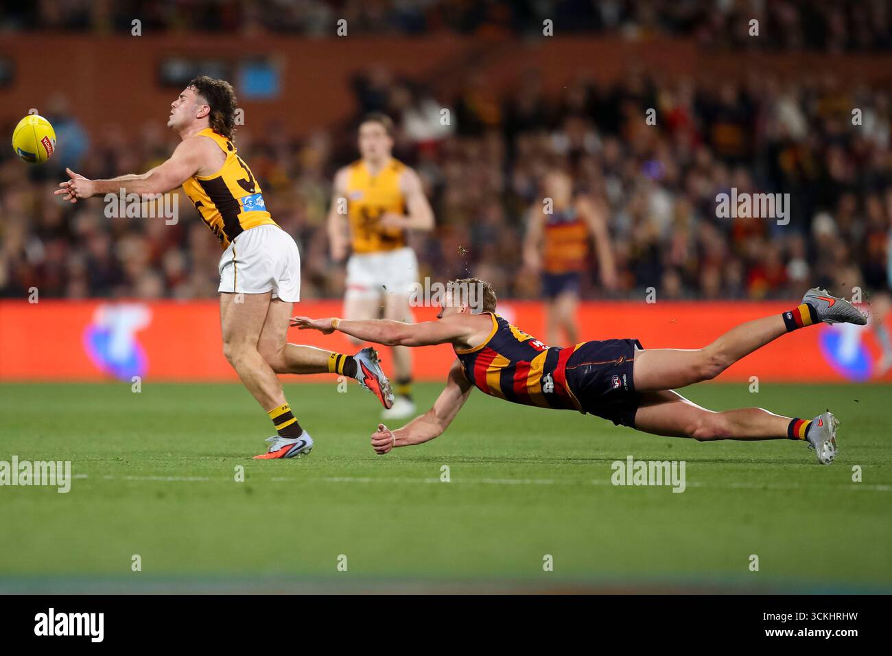 Nick Watson of the Hawks breaks away from Mitchell Hinge of the Crows ...