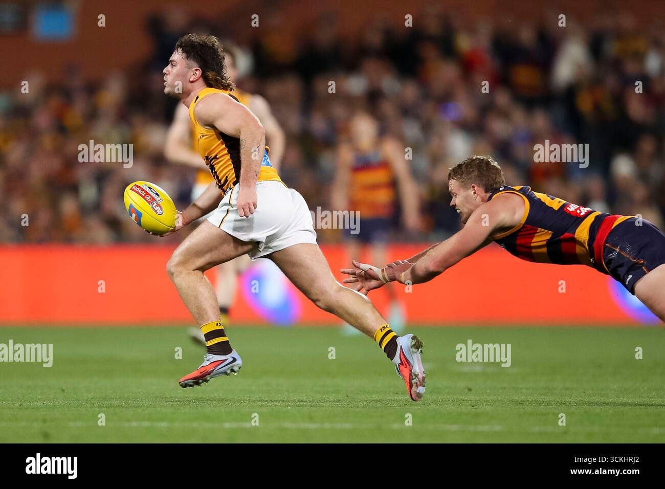 Nick Watson of the Hawks breaks away from Mitchell Hinge of the Crows ...