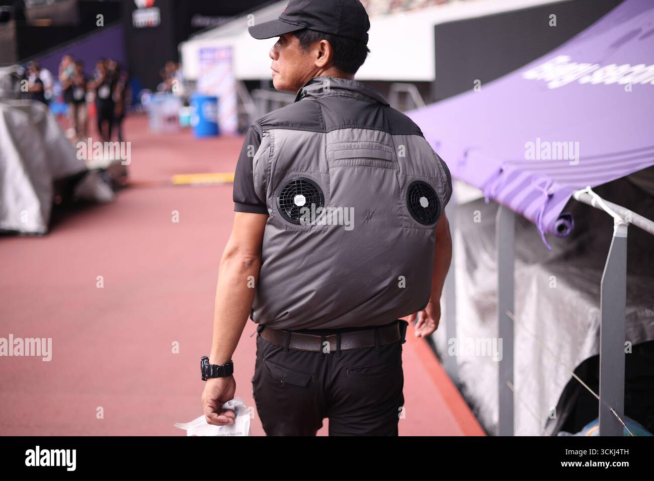 Japanese staff wear jackets with fans in to cope with the extreme heat ...