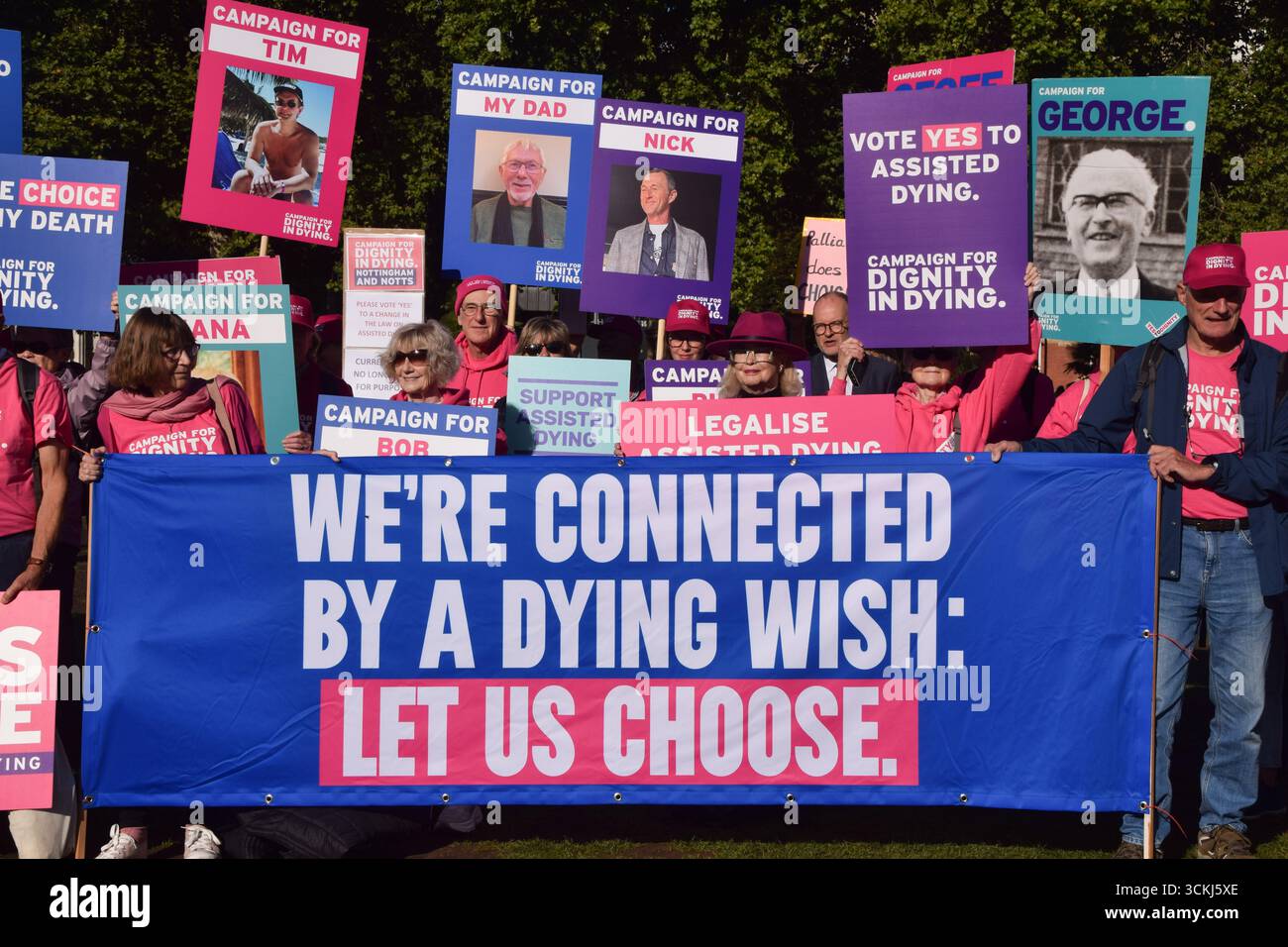 Protesters hold a banner and placards in support of the Assisted Dying ...