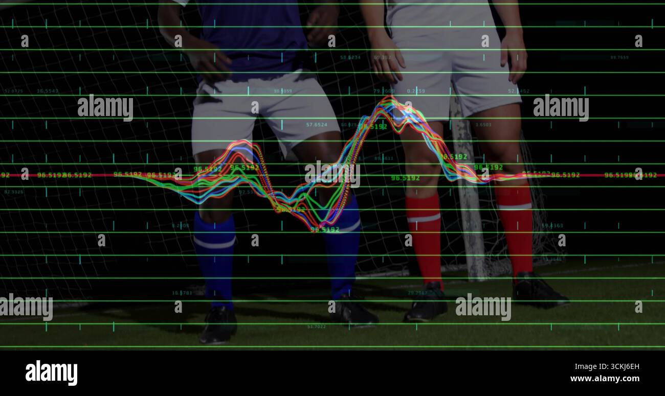 Standing two soccer players wearing blue, white jerseys on soccer pitch ...