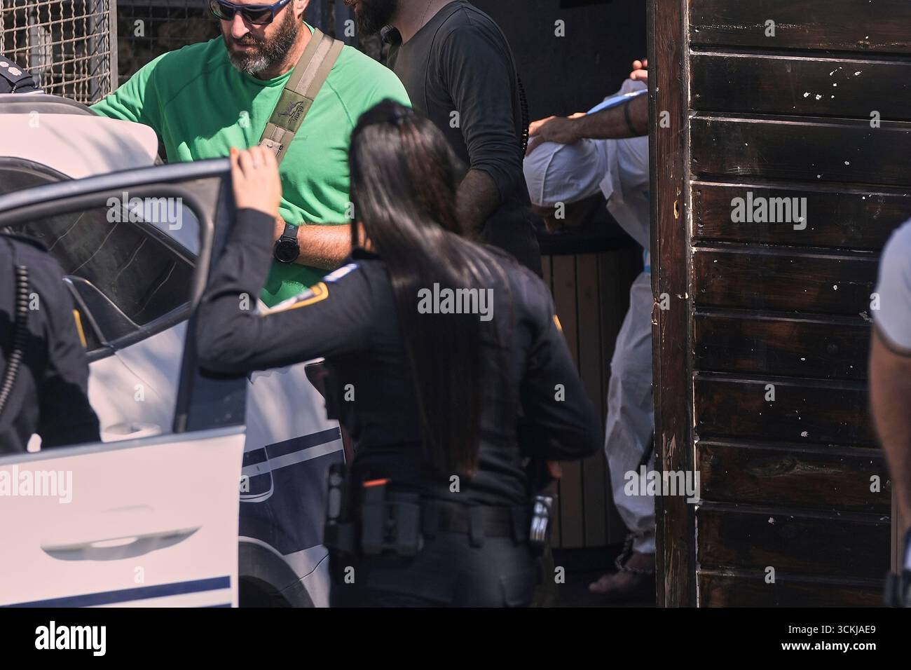 Members of the Israeli security forces detain a suspect in a stabbing ...
