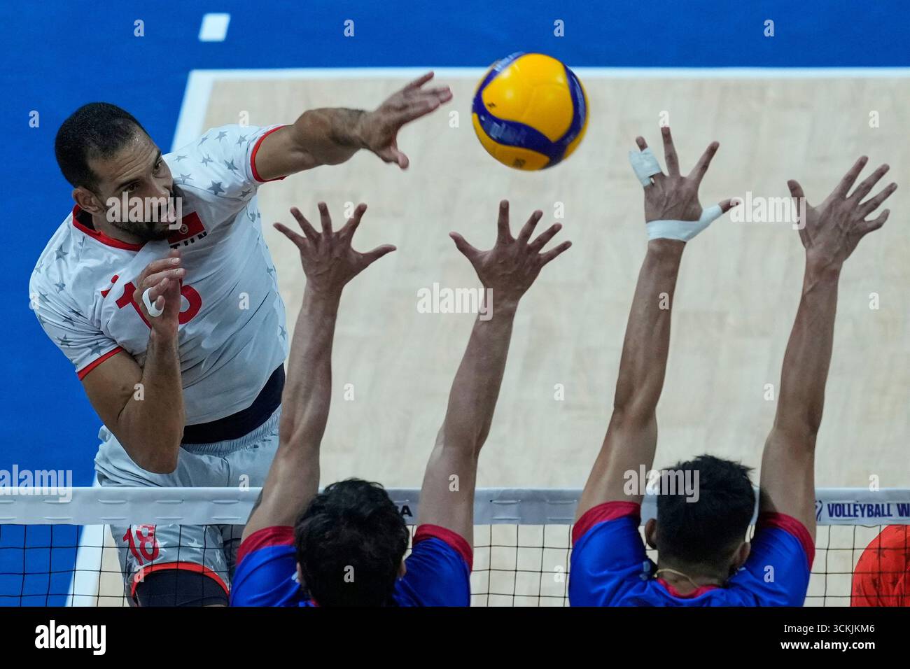 Ali Bongui, left, of Tunisia spikes the ball against Philippines Marck ...