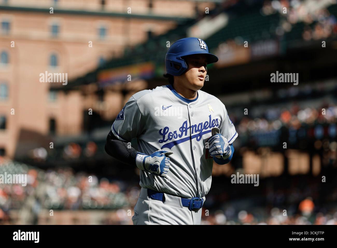 Los Angeles Dodgers' Shohei Ohtani jogs off the field during the ...