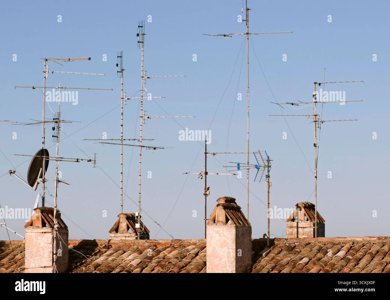 terracotta tile roof with chimneys and antennas, Italy Stock Photo - Alamy