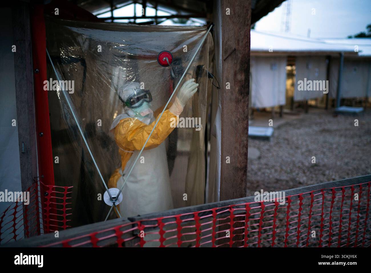 FILE - A health worker wearing protective suit enters an isolation pod ...