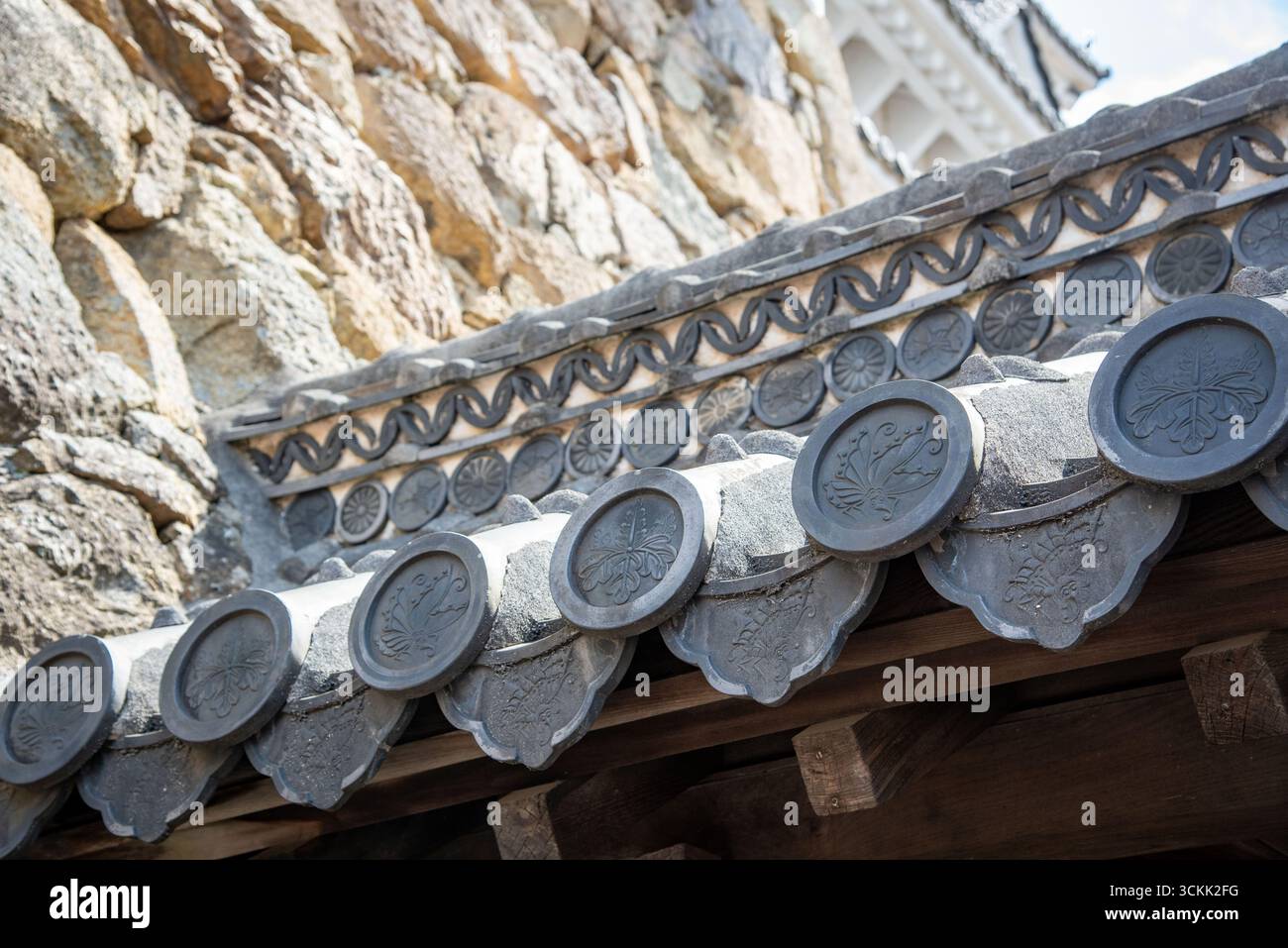 Himeji Castle Ornamental Roof Tiles and Stone Wall. Detail of Himeji ...