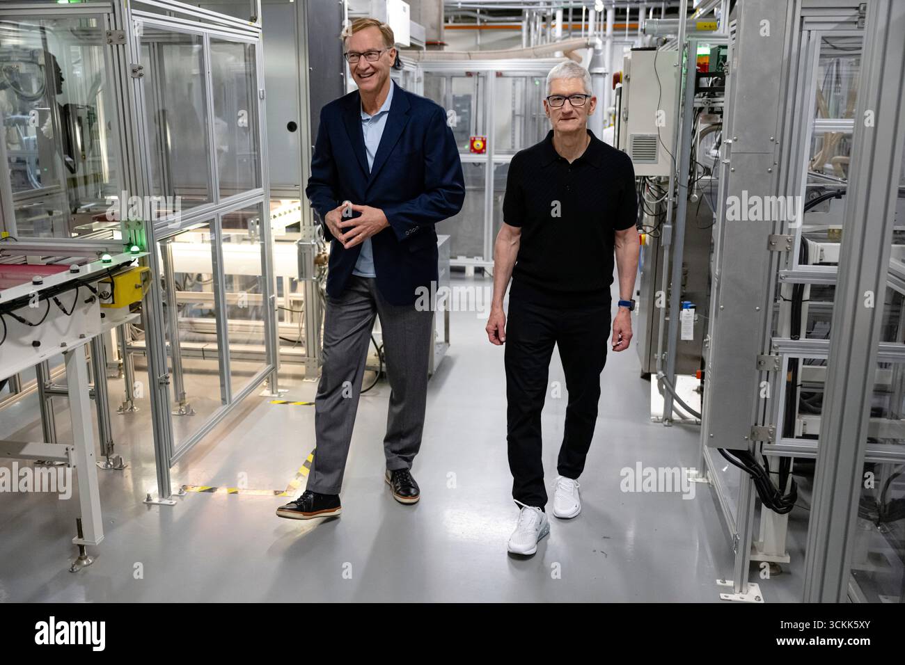 Apple CEO Tim Cook and Corning CEO Wendell Weeks walk during a tour of ...