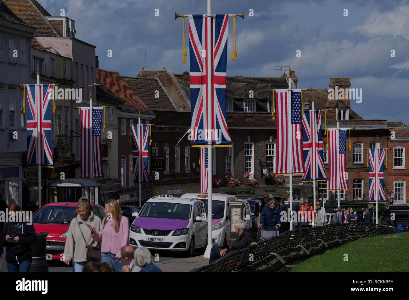 U.S. flags and Union flags are lined on a road outside the Windsor ...