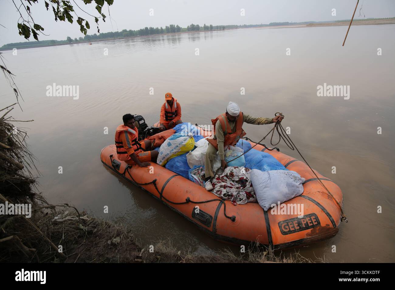 Floods aftermath in India A volunteer R, loads relief material to be ...