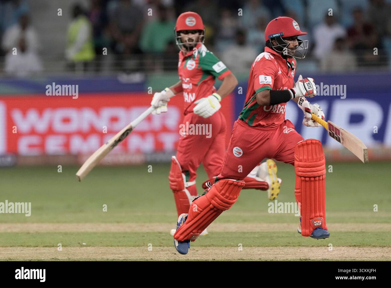 Oman's Aamir Kaleem, right, and Hammad Mirza run between the wickets to ...