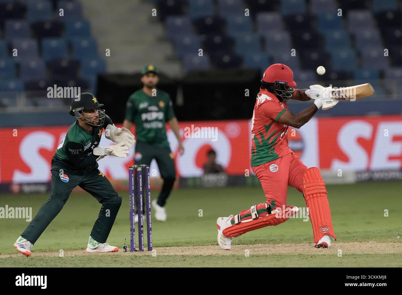 Oman's Mohammad Nadeem, right, plays a shot during the Asia Cup Cricket match between Oman and ...