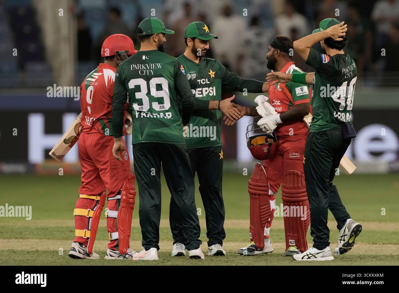 Pakistan's and Oman's players shake hands after Pakistan won during the ...