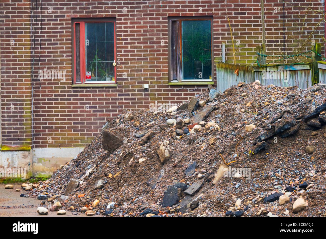 pile of excavated soil and rubble near brick building Stock Photo - Alamy