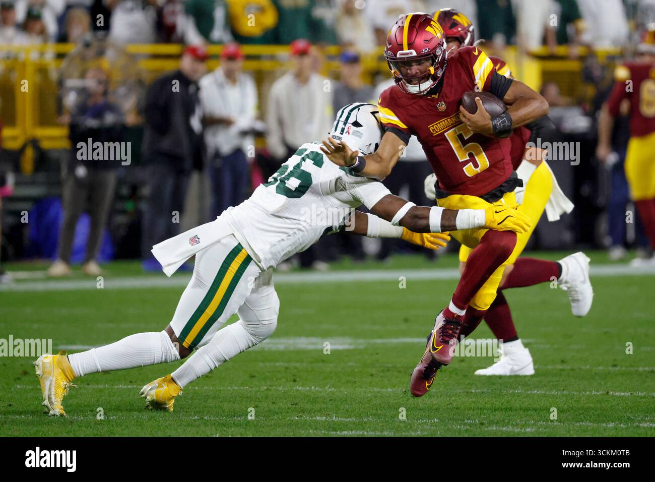 Washington Commanders quarterback Jayden Daniels tries to elude Green ...