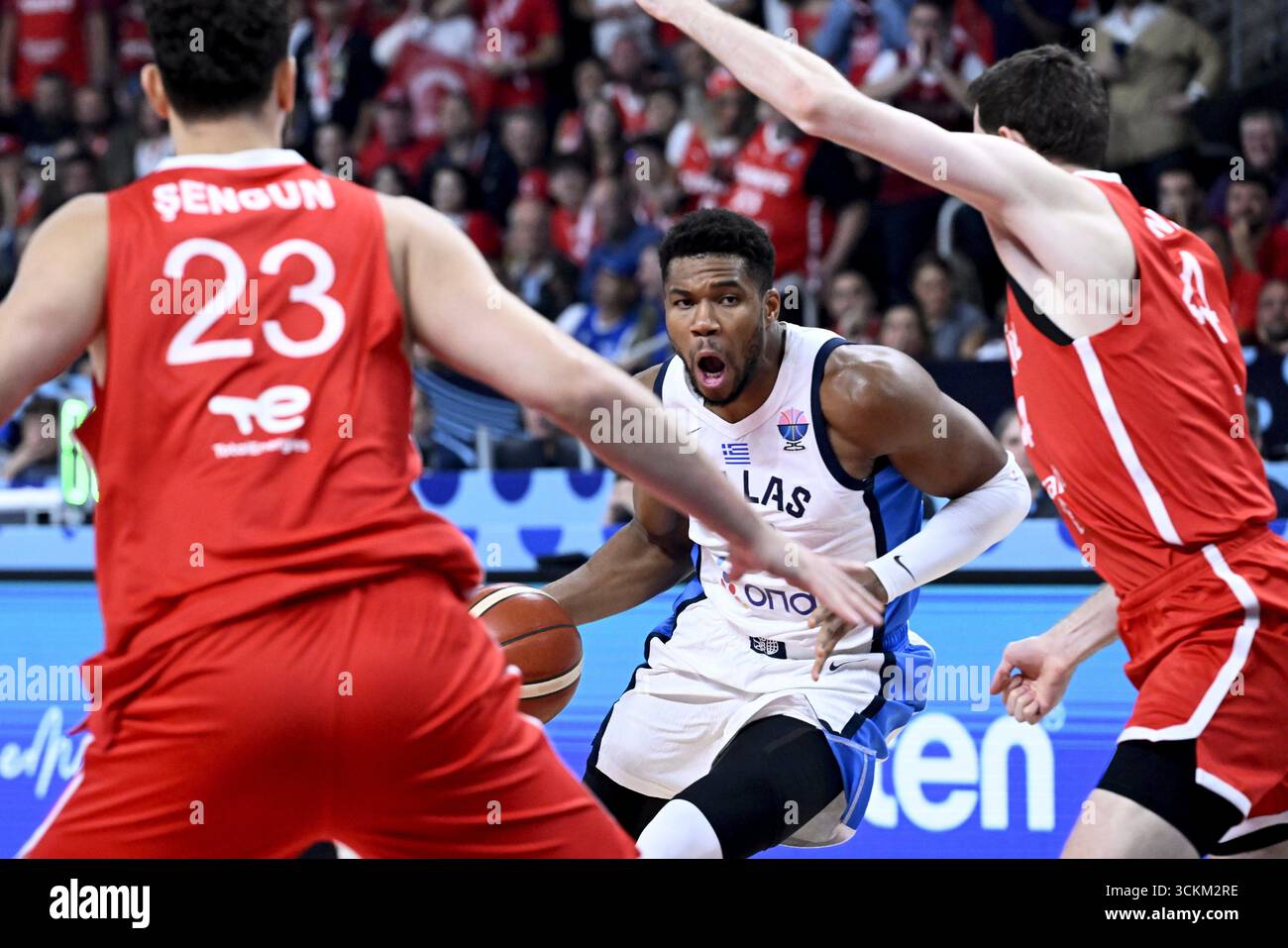 Giannis Antetokounmpo of Greece plays against Alperen Sengun (L) and Ercan Osmani of Turkey ...