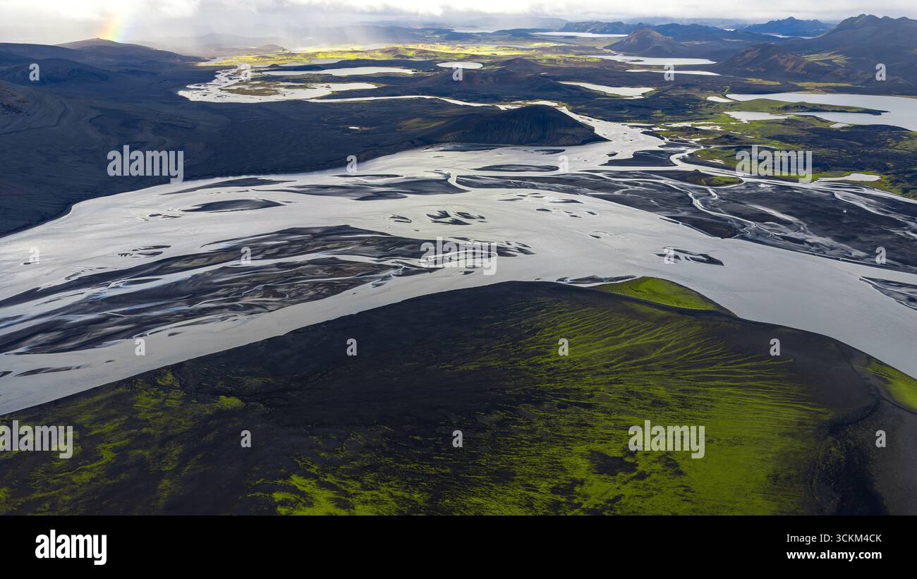 Aerial perspective of Iceland's volcanic landscape with winding rivers ...