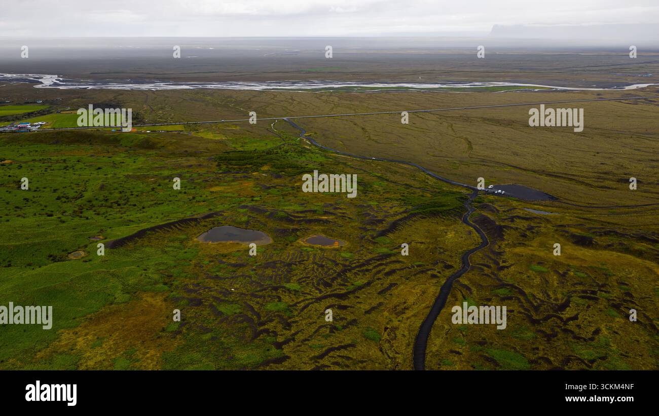 Aerial perspective of Iceland's green mossy terrain, dark volcanic soil ...