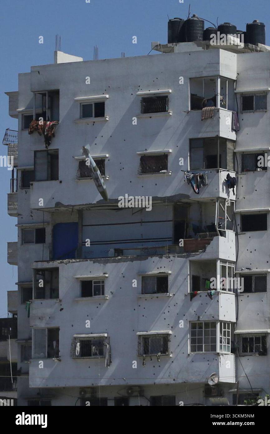 A bomb flies in the air as it approaches a building during an Israeli ...