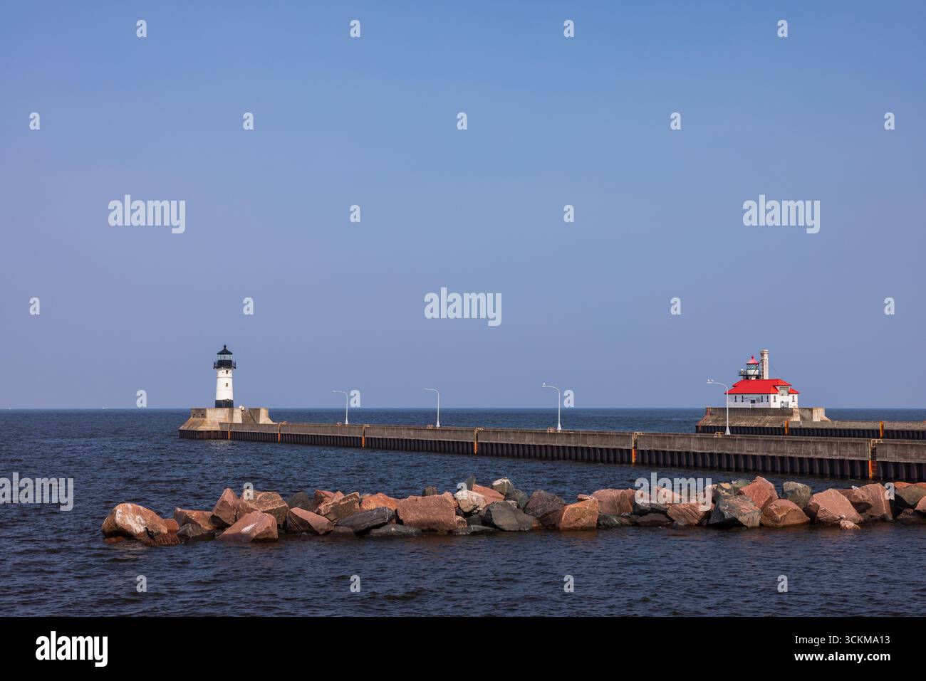 Two breakwater lighthouses mark the entrance to a harbor on Lake ...