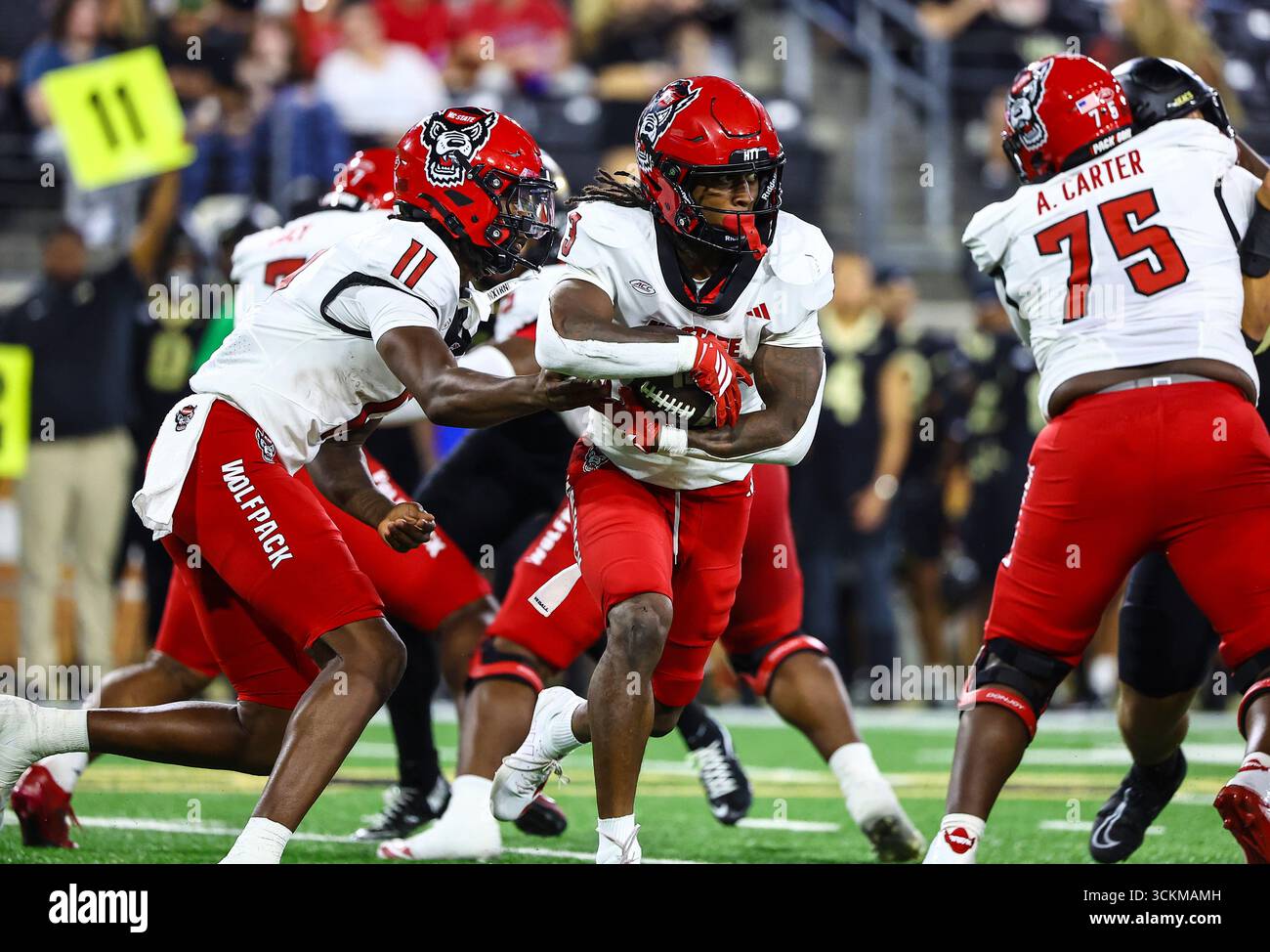 September 11,2025: NC State quarterback CJ Bailey (11) hands off to NC ...