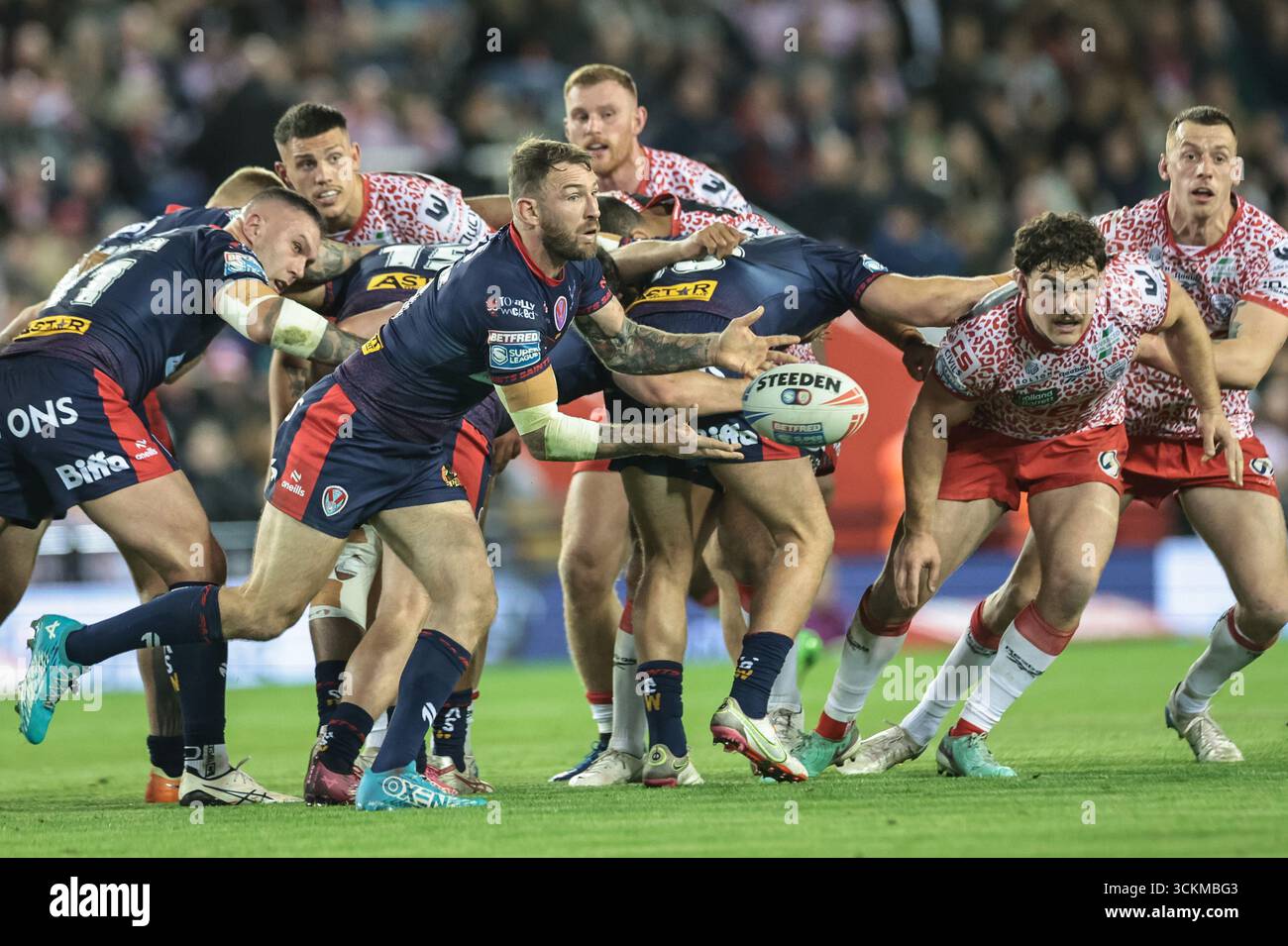 Daryl Clark of St Helens off-loads during the Betfred Super League ...