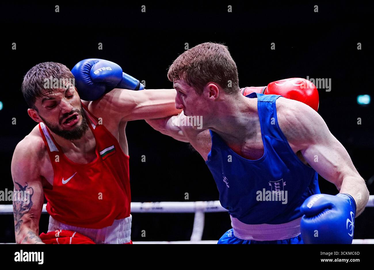 Rami Kiwan (red) of Bulgaria in action against Callum Makin (blue) of ...